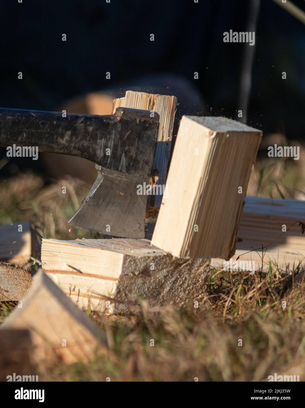 A vertical shot of an ax with cut wooden pieces Stock Photo - Alamy
