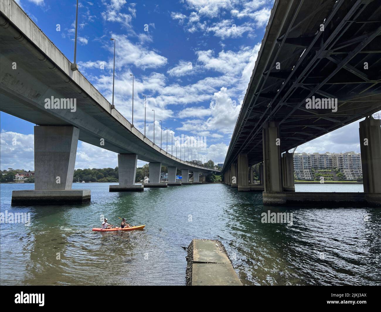 Two people Kayaking through two bridges, Iron Cove Creek pedestrian ... Two people Kayaking through two bridges, Iron Cove Creek pedestrian ...