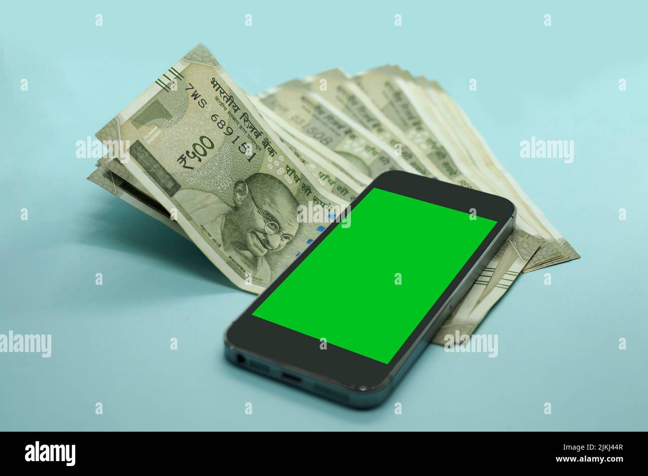 The Indian currency - 500 rupee notes and the phone with green screen ...