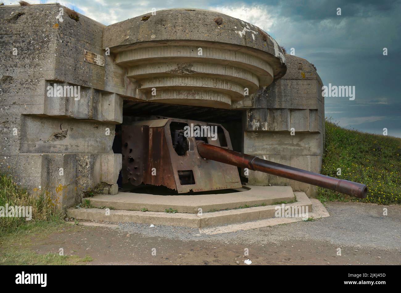A beautiful shot of a German bunker with intact tank weapon against ...