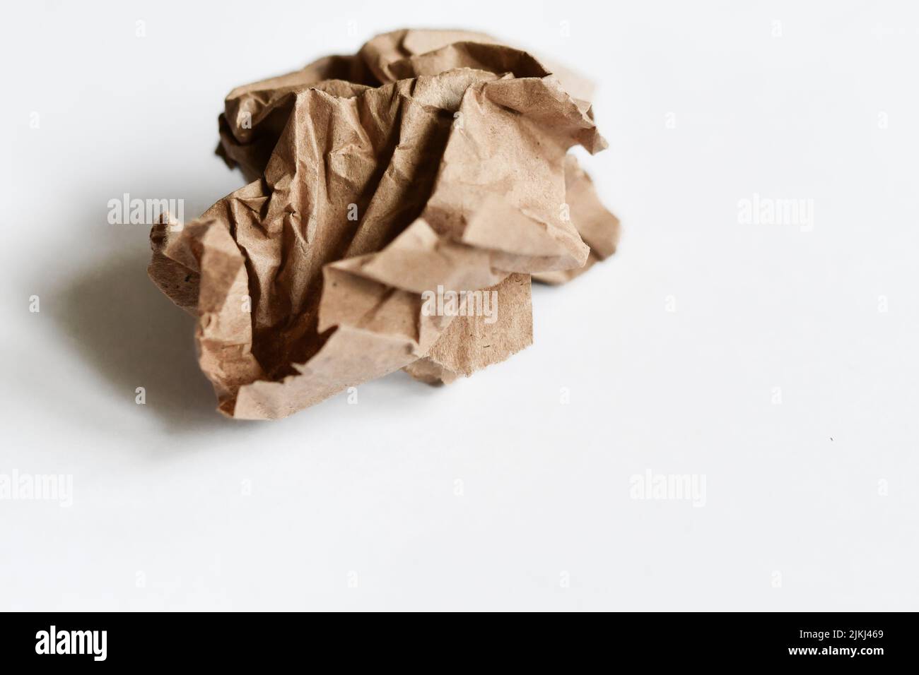 Crumbled brown paper on white background, concept of bad idea Stock ...