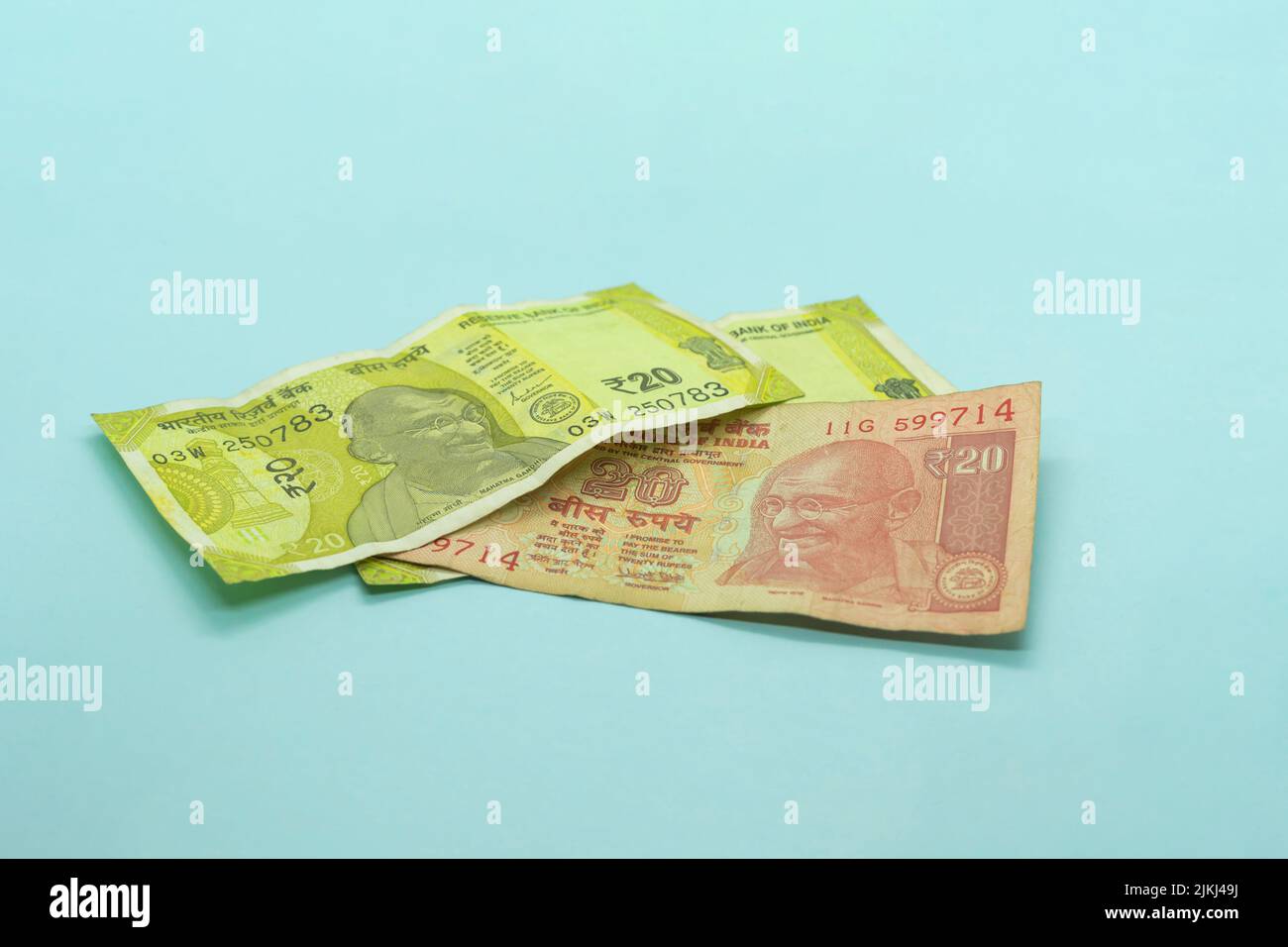 The Indian currency - old and new 20 rupee notes on the blue background ...