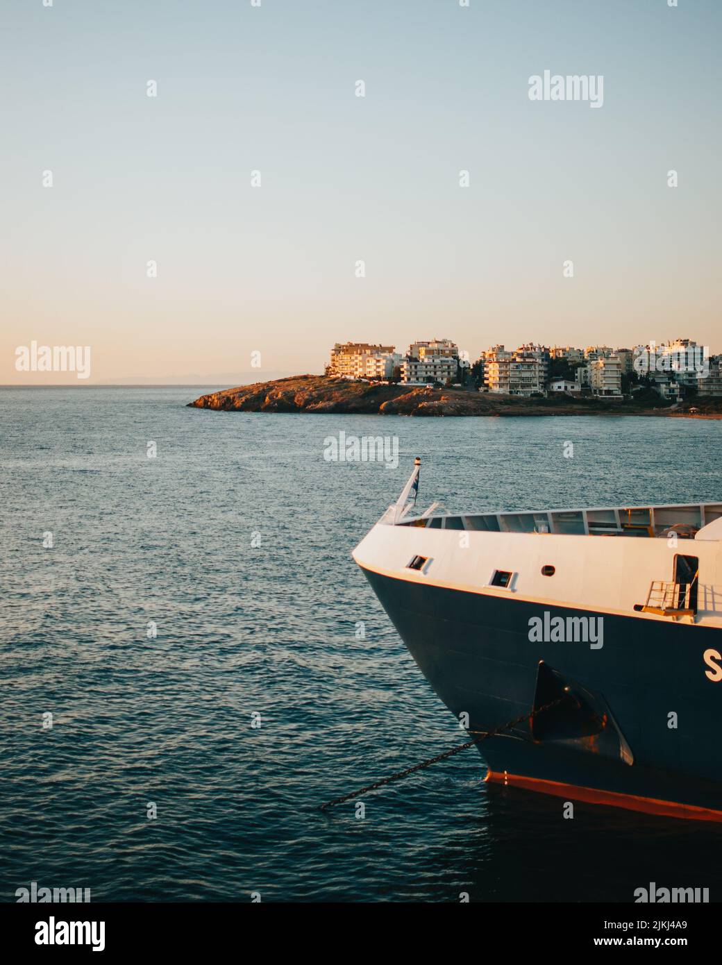Vertical shot of a port with the front of a ship at sunset Stock Photo ...