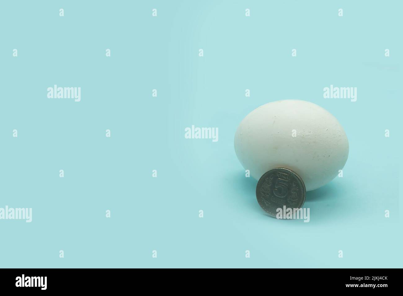 The Indian currency - 5 rupees coin note with egg on the blue ...