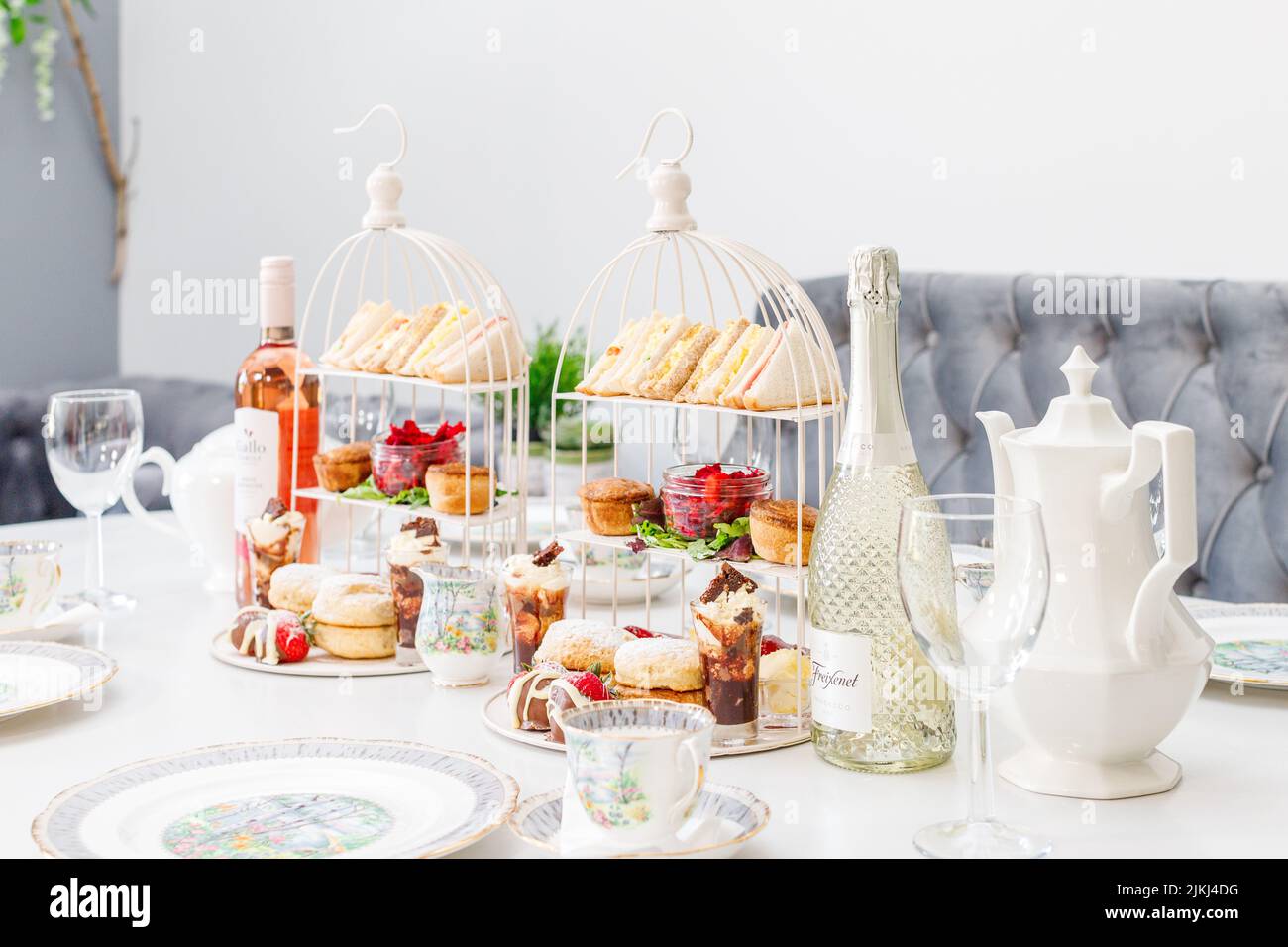 A celebratory afternoon tea table with scones, cakes and sandwiches ...