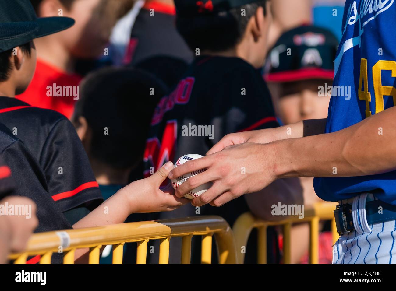 The California State University Bakersfield player signs a baseball for ...