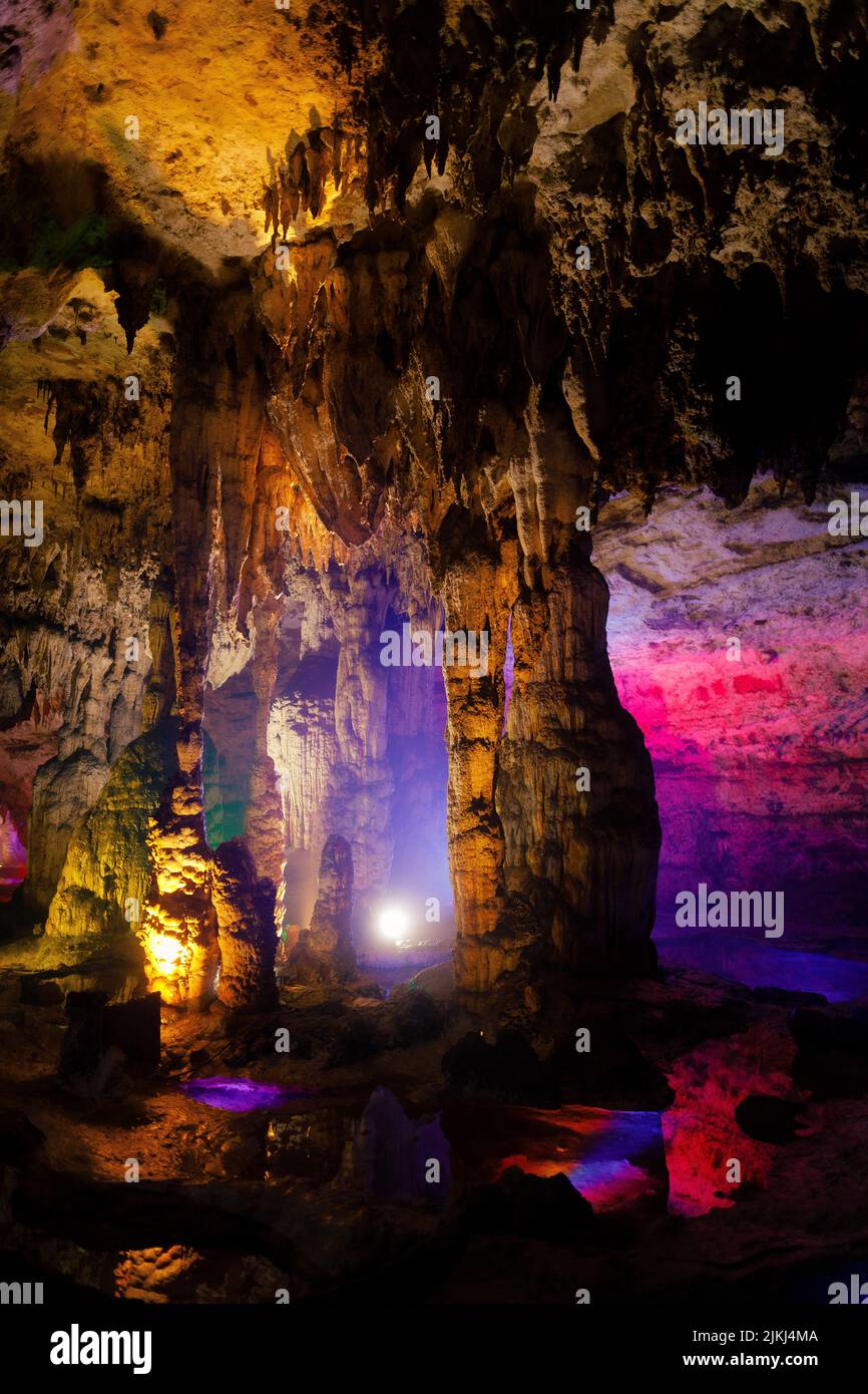 A scenic inside view of the Shuanghedong Caves with colorful lights ...