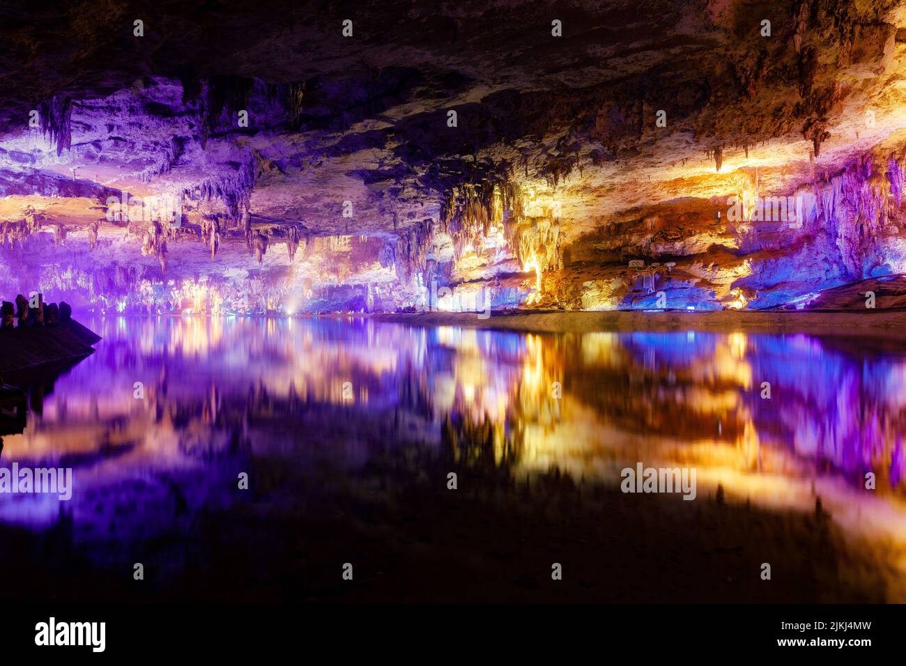 A scenic inside view of the Shuanghedong Caves with colorful lights ...