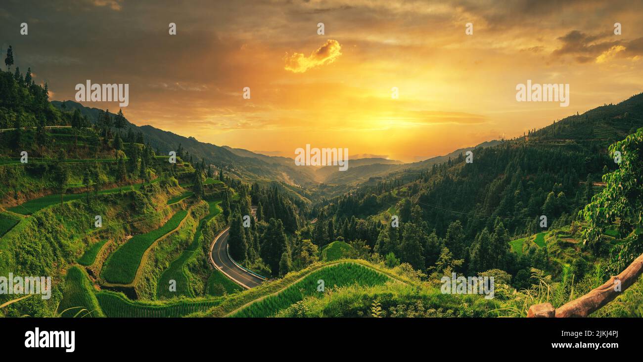 A breathtaking landscape view of green mountains against beautiful dusk ...