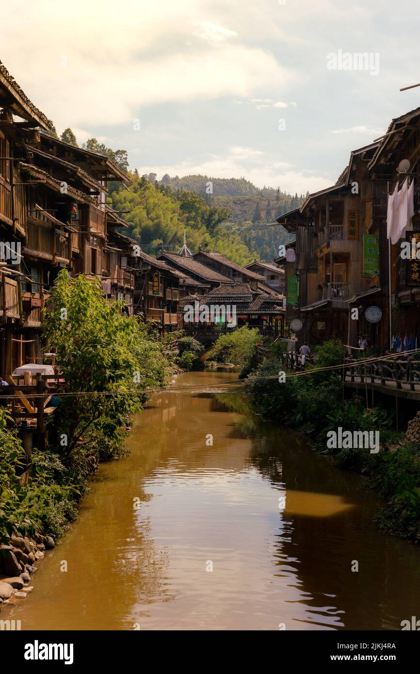 A beautiful shot of the river flowing between the old traditional ...