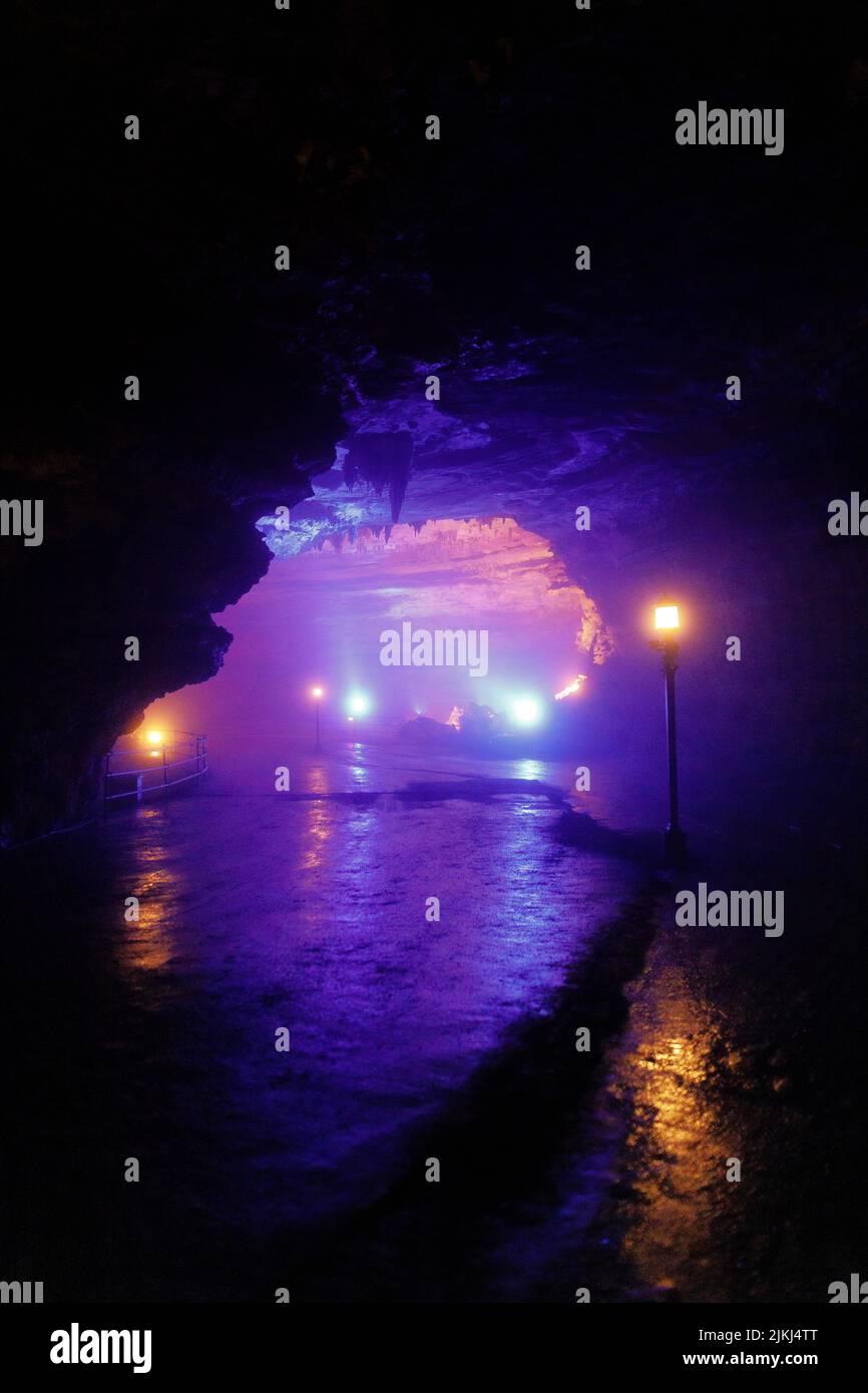 A scenic inside view of the Shuanghedong Caves with colorful lights ...