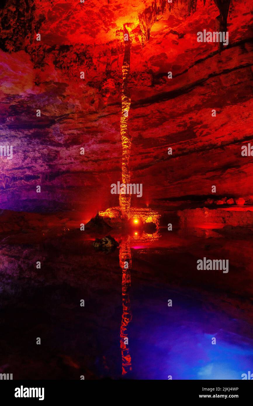 A scenic inside view of the Shuanghedong Caves with colorful lights ...