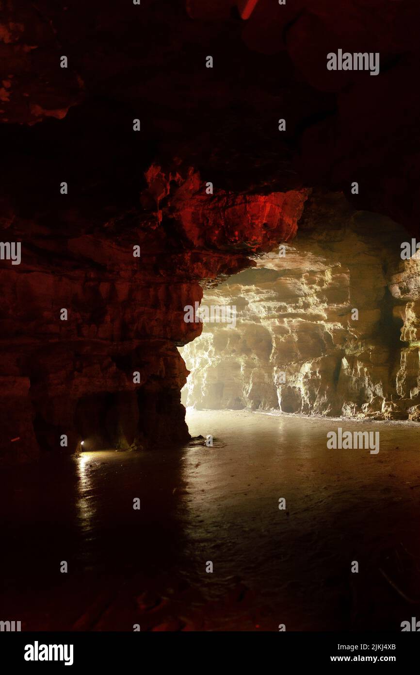 A scenic inside view of the Shuanghedong Caves with colorful lights ...