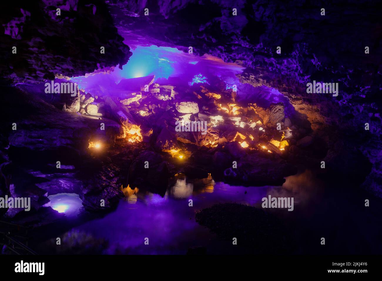 A scenic inside view of the Shuanghedong Caves with colorful lights ...