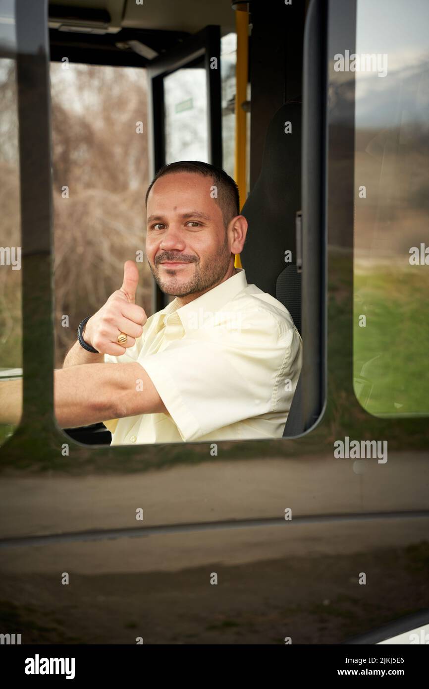 A vertical close up shot through an open window of a bus driver Stock ...