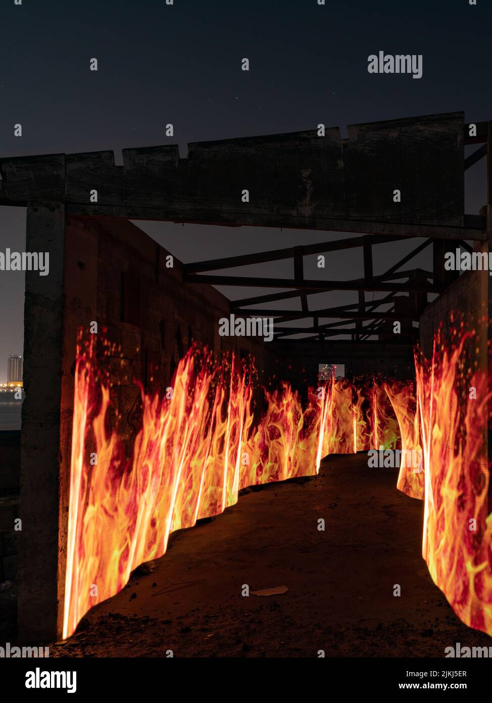 A vertical shot of illuminated fire designs near a building Stock Photo ...