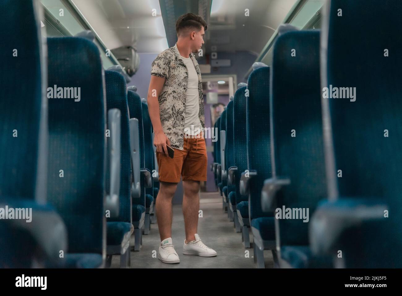 Young man standing inside hi-res stock photography and images - Alamy