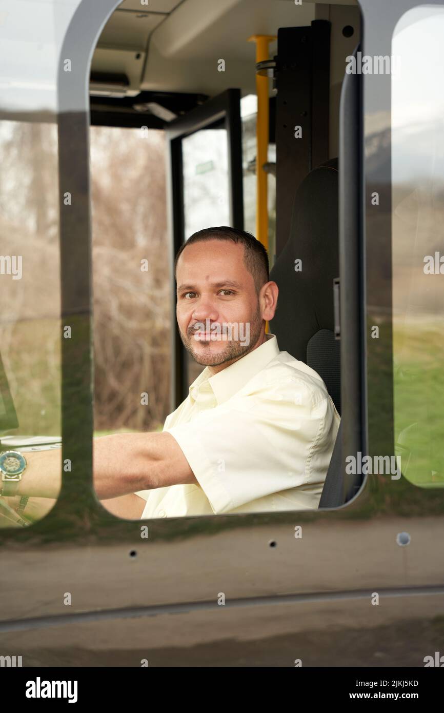 A vertical close up shot through an open window of a bus driver Stock ...