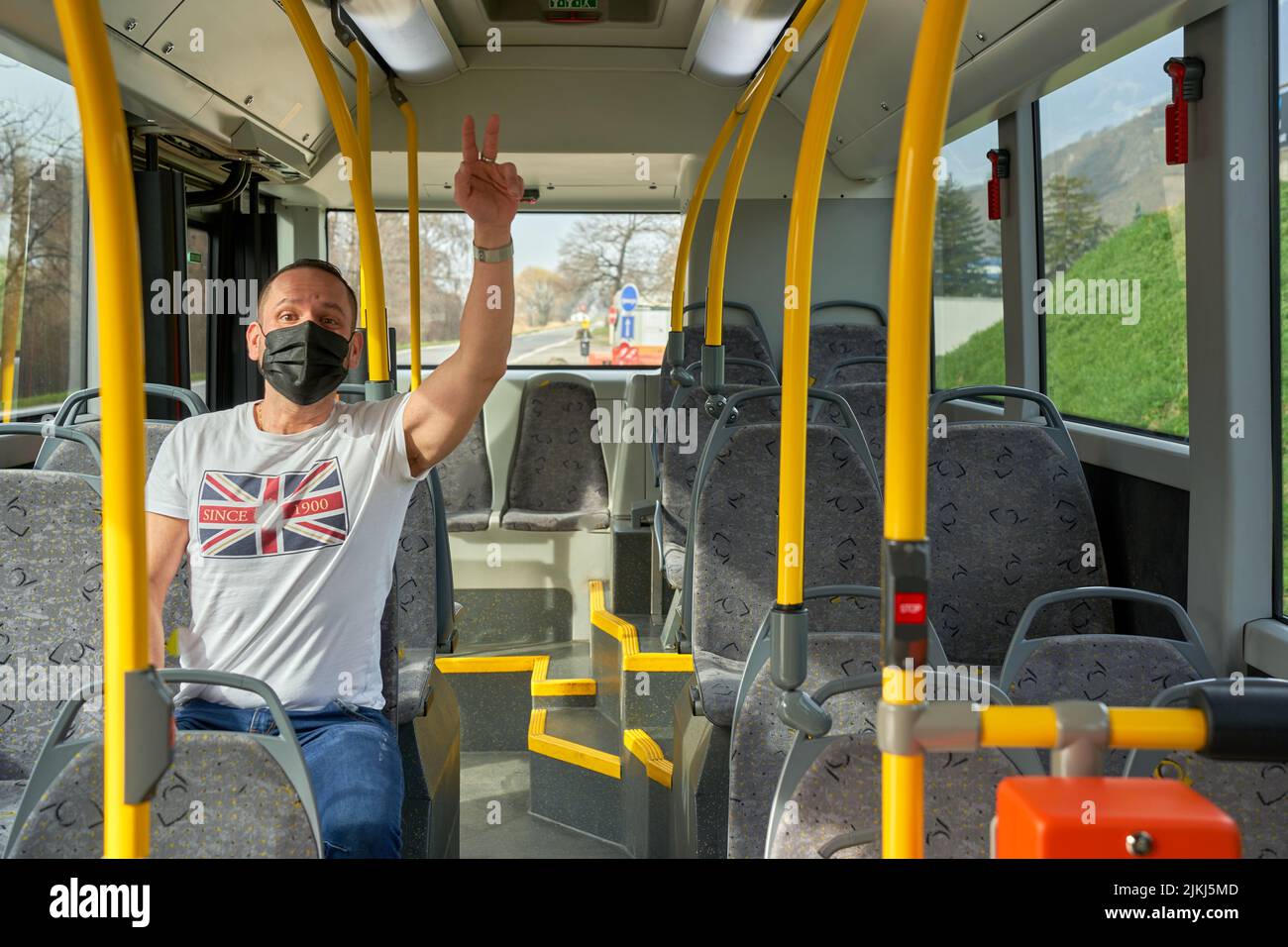 A male passenger asking the driver to stop the bus with a hand gesture ...