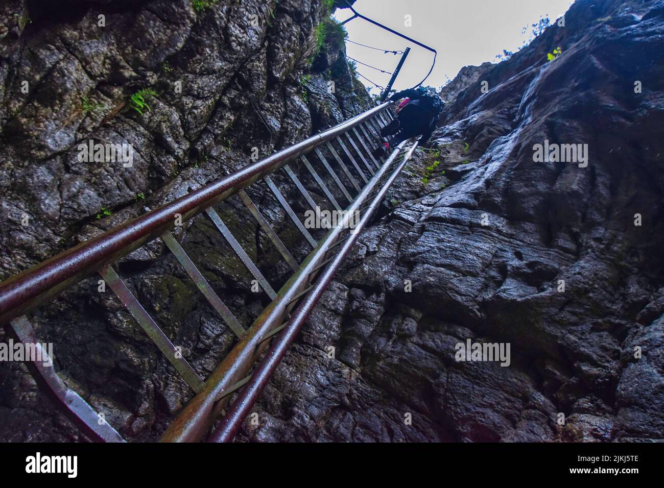 A low angle of a man climbing ladder in the mountains of Slovakia Stock ...