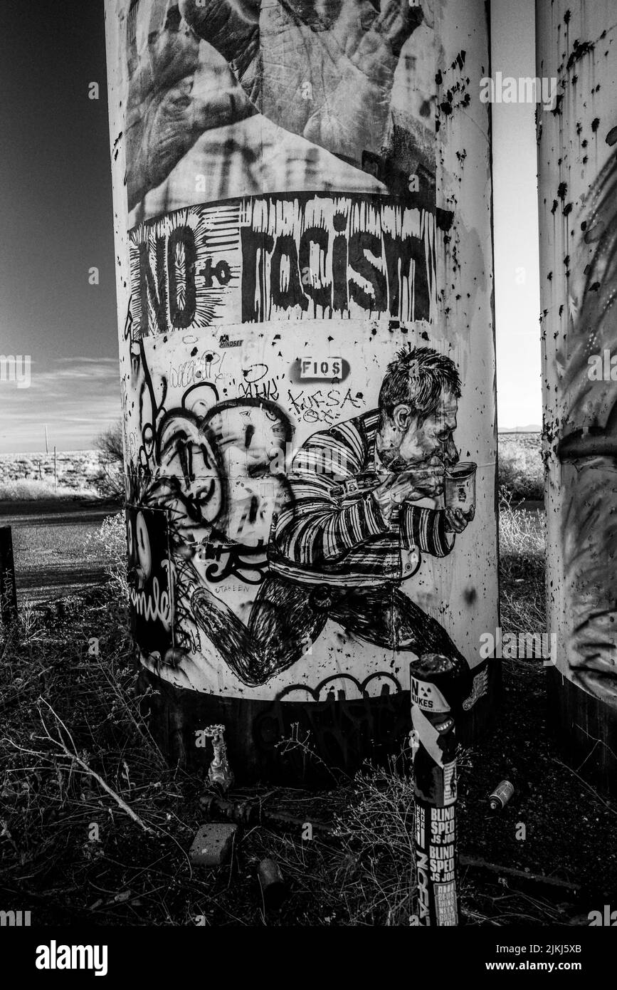 A vertical shot of a beautiful graffiti with a sign NO to racism in ...