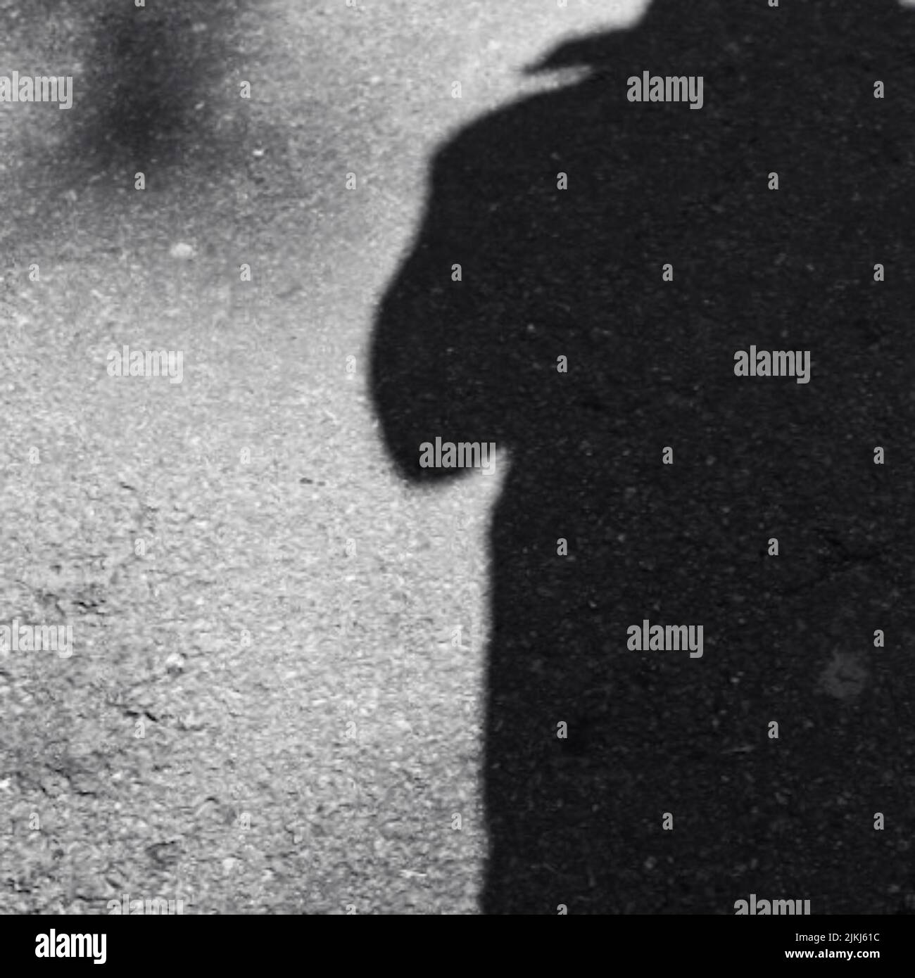 A shadow of someone walking on the street in grayscale colors Stock ...