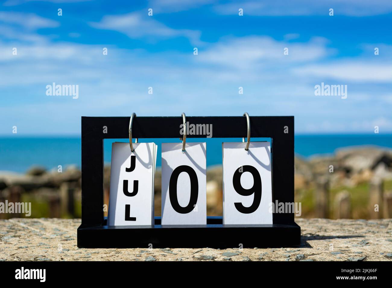 Jul 09 calendar date text on wooden frame with blurred background of ...