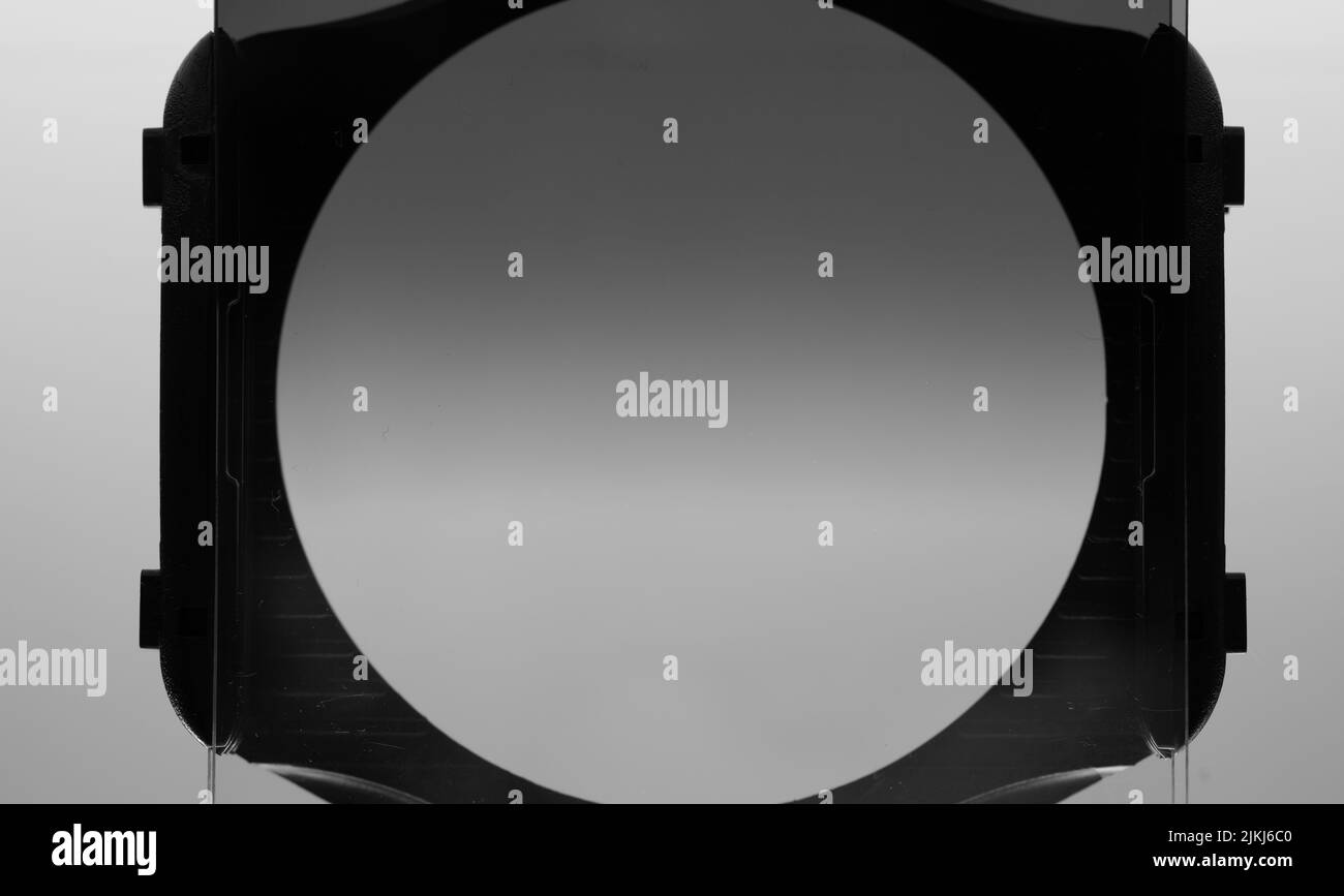 A camera filter holder used for photography isolated in grey background ...