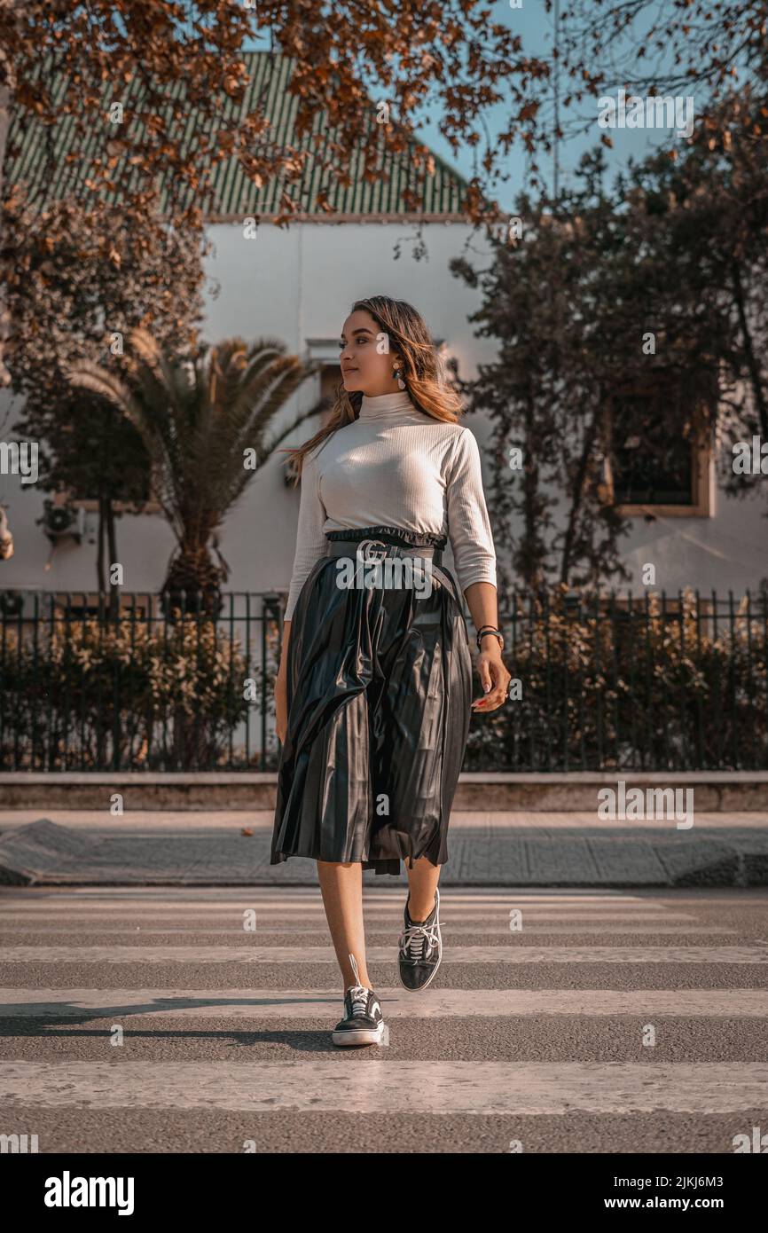 Portrait of aBeautiful young lady crossing the road Stock Photo - Alamy