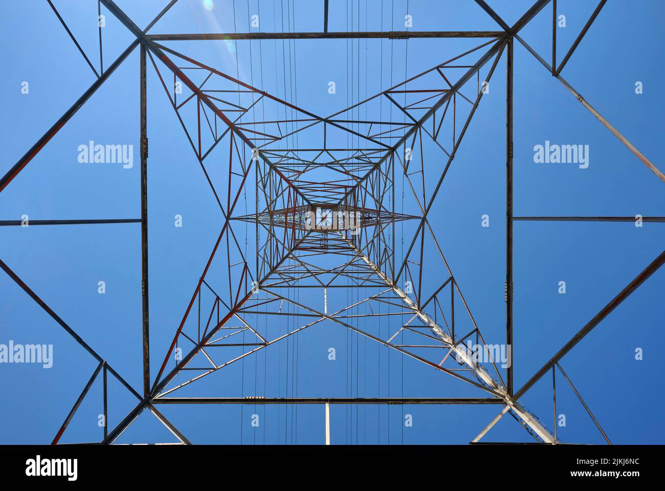 A Transmission tower view from below looking straight up against the ...