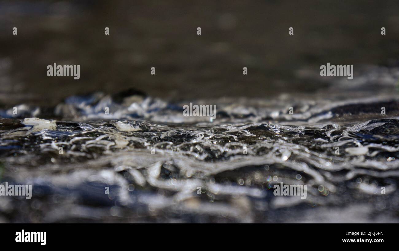 A selective of water surface covering the stones Stock Photo - Alamy