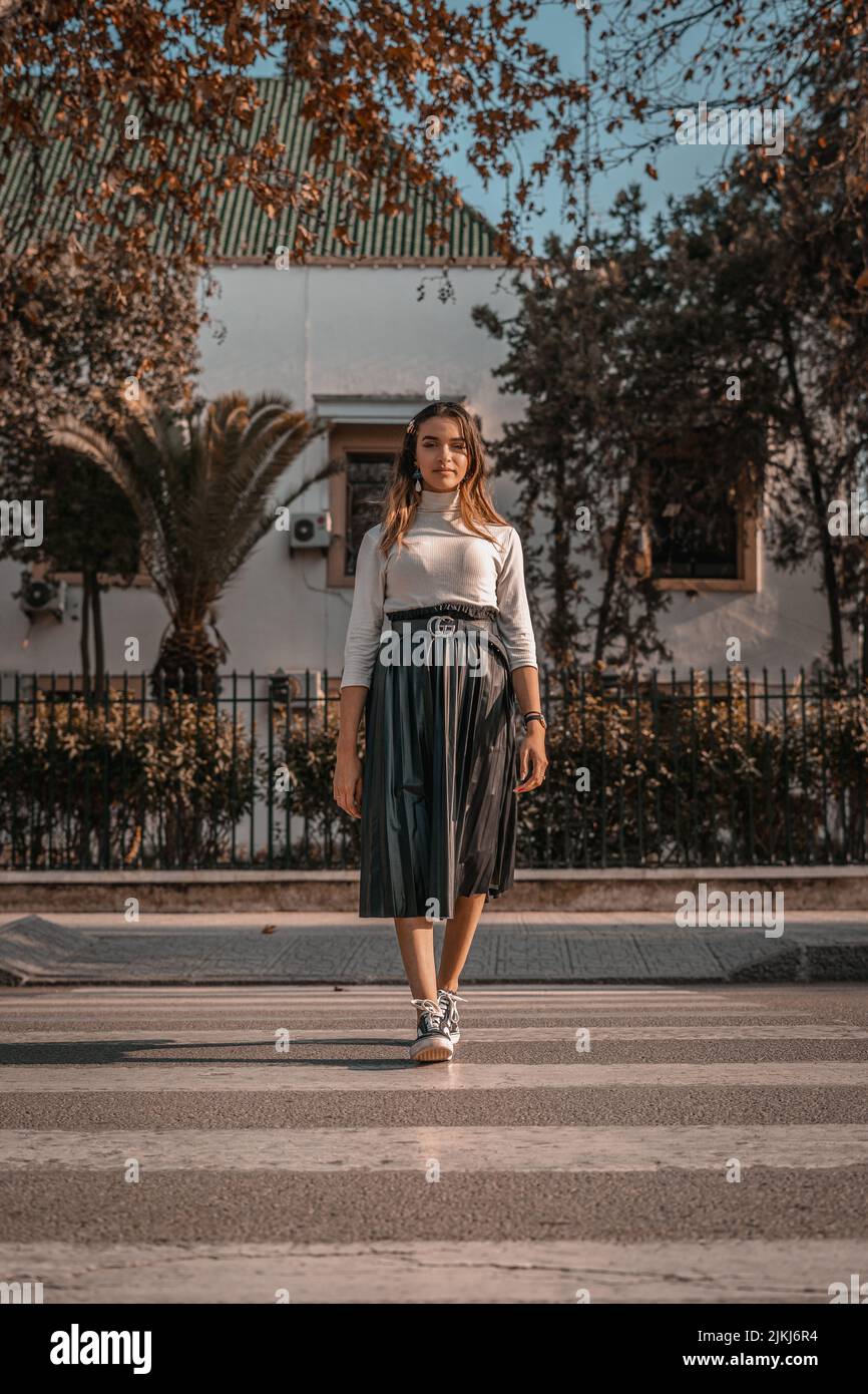 Portrait of a beautiful young lady crossing the road Stock Photo - Alamy