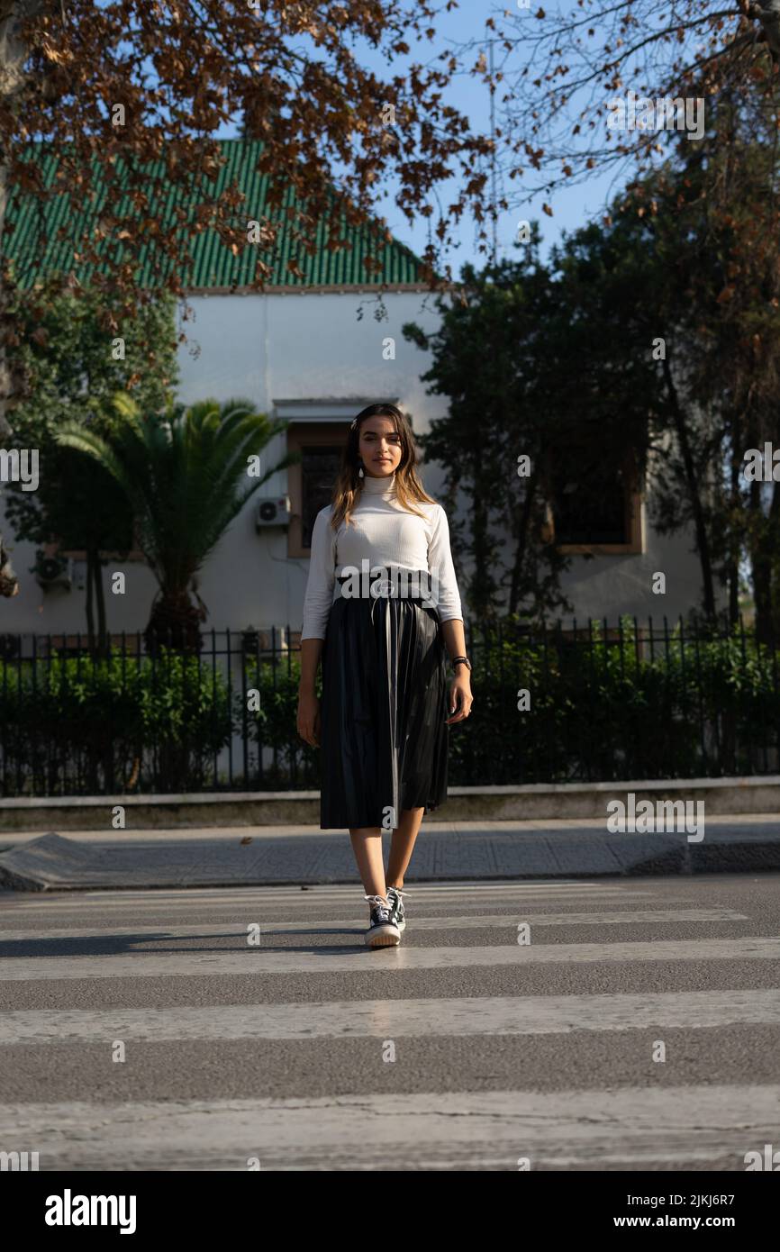 Portrait of a beautiful young lady crossing the road Stock Photo - Alamy