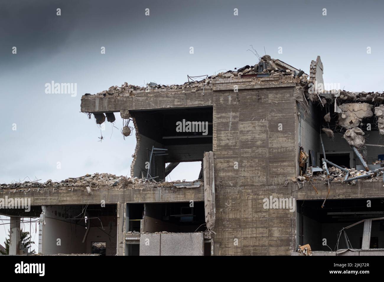 An old destroyed building with crushed walls on a blue sky background ...
