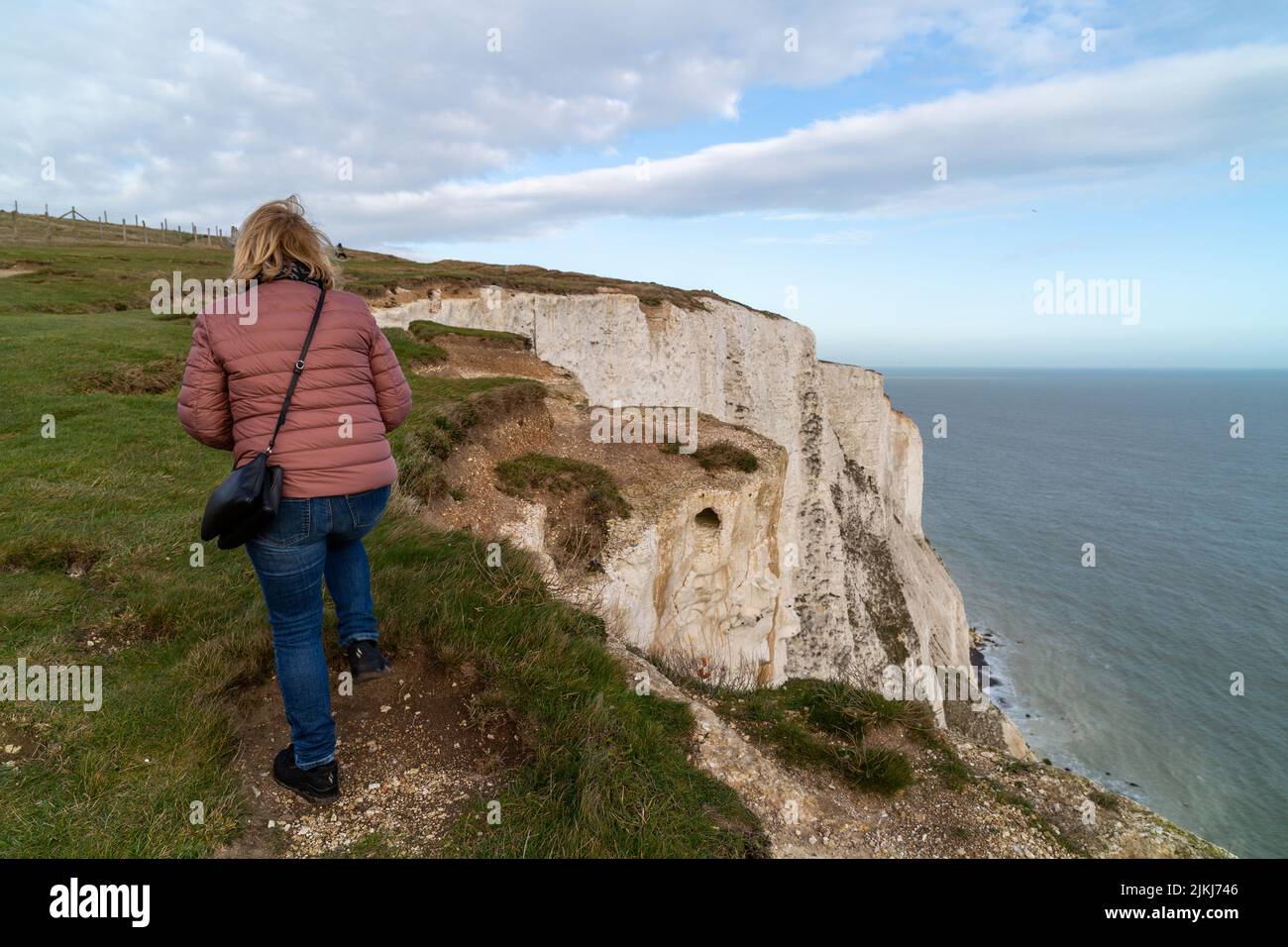 A back view of a woman walking at The White Cliffs of Dover Kent, UK ...