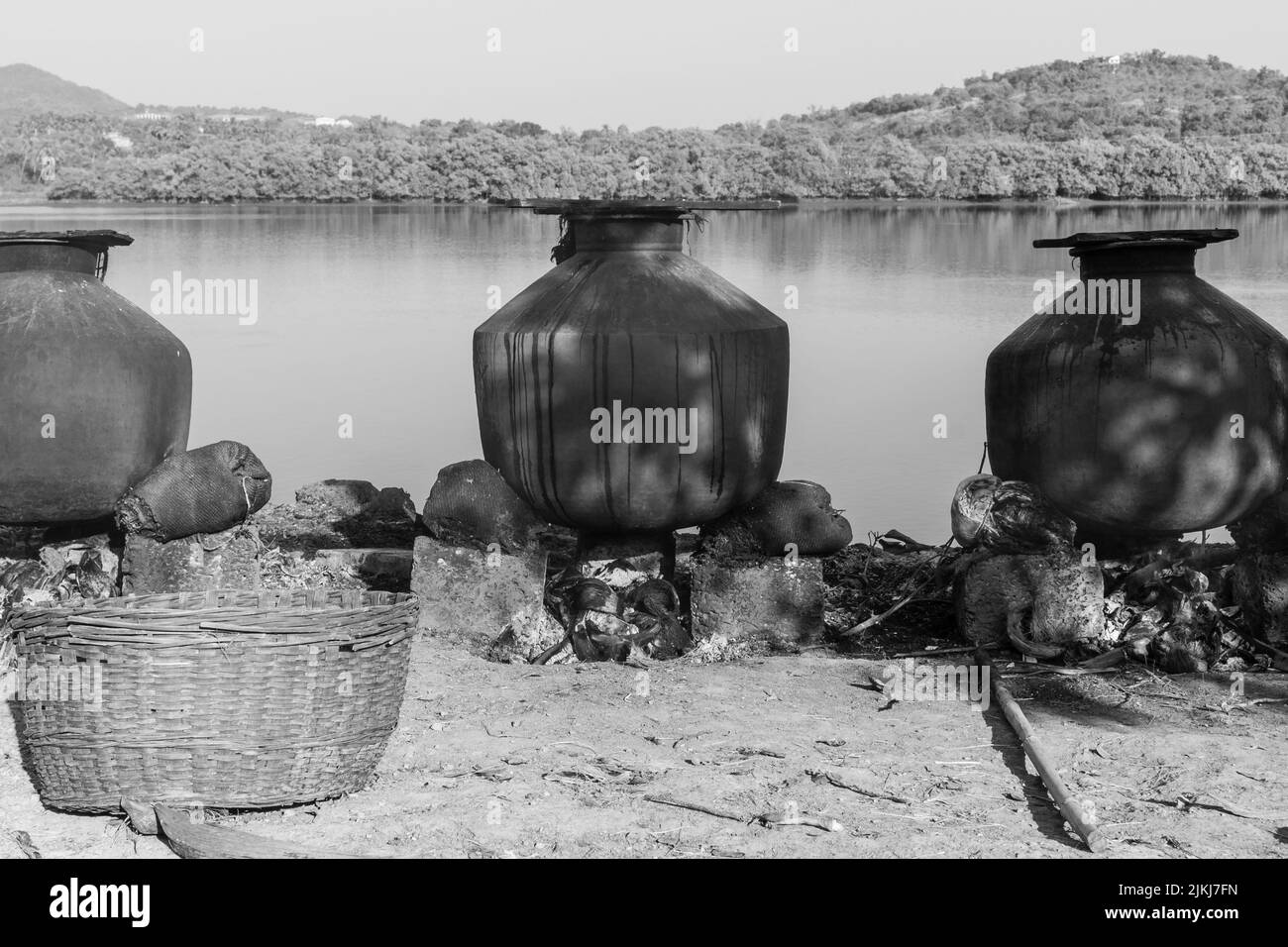 A grayscale shot of old and traditional huge clay pots for cultivating ...