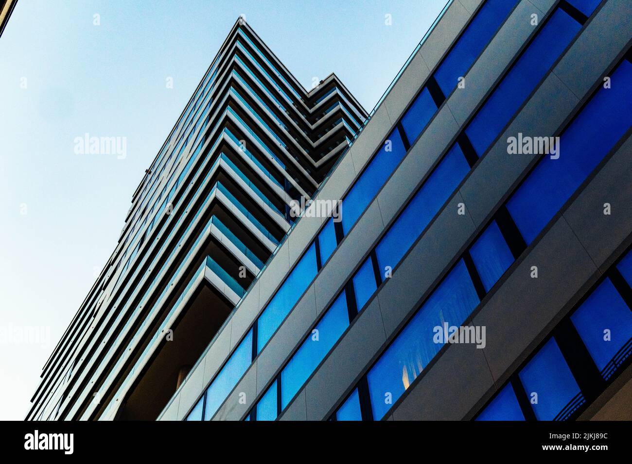 A low angle shot of a modern building with blue windows in Germany ...