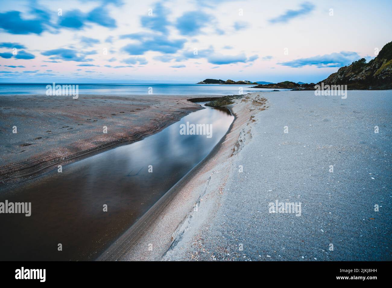 A beautiful view of Ocean Beach in Hawke's Bay, New Zealand, and a blue ...