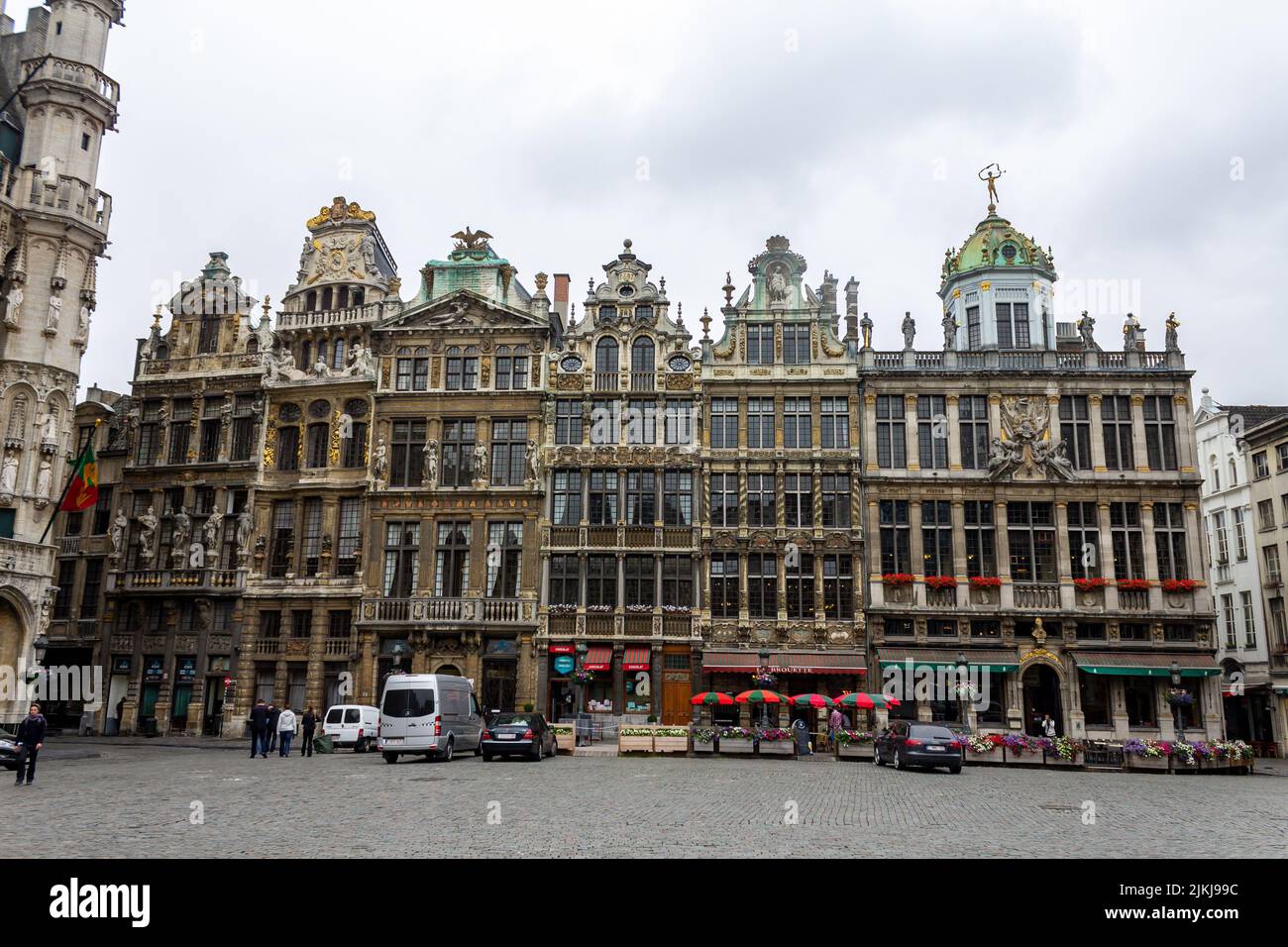 Old historical buildings in downtown Brussels with light grey clouds in ...