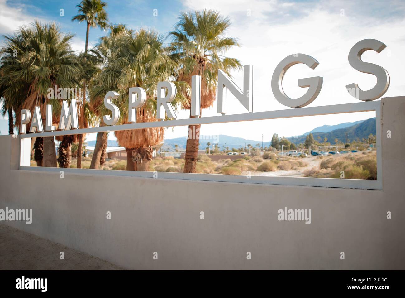 A photo of Palm Springs sign in the desert with palm trees Stock Photo ...