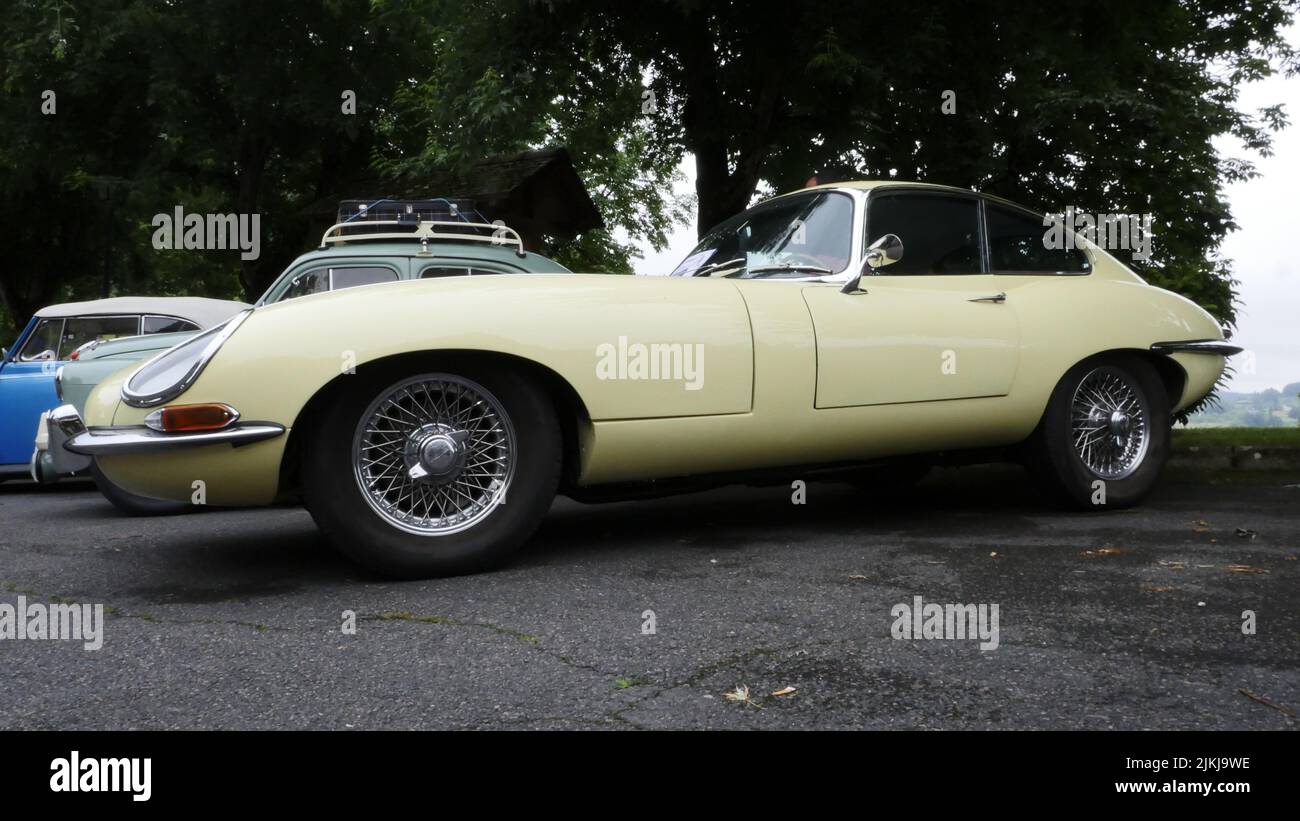 An old vintage yellow Jaguar E-Type parked outdoors Stock Photo - Alamy