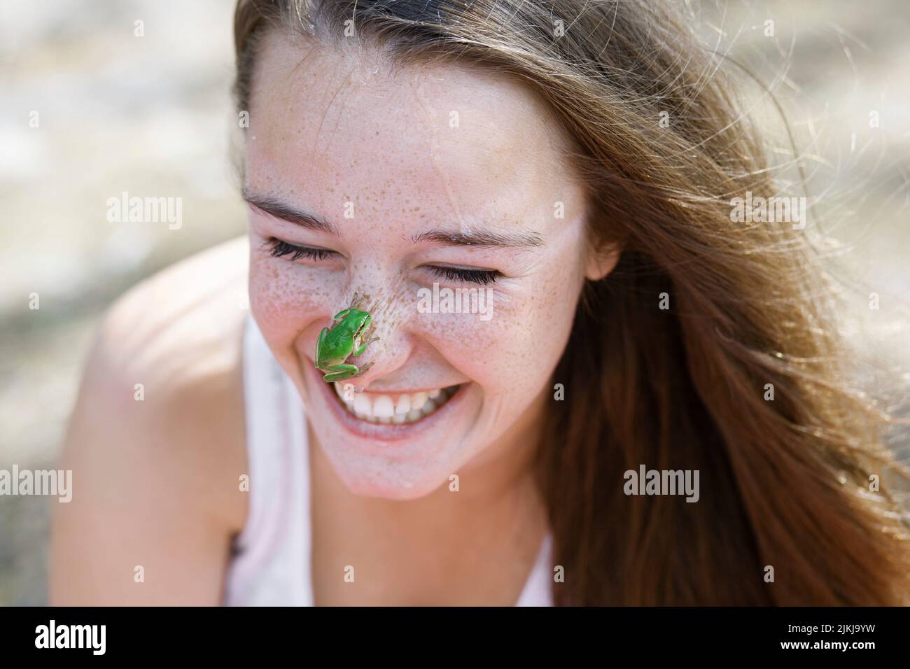 young woman with frog on nose Stock Photo - Alamy