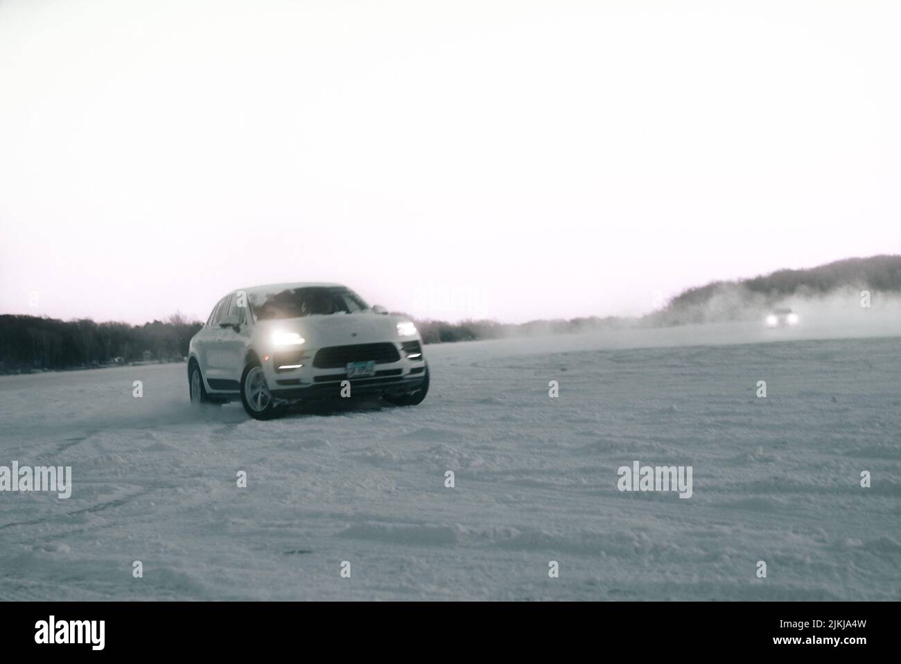 A white Porsche Cayenne car drifting on ice and snow in Juneau, Alaska ...