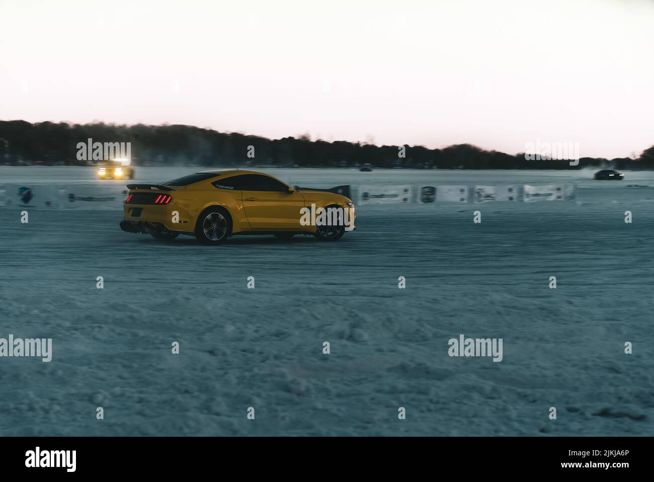 A yellow sports car drifting on ice and snow in Juneau, Alaska Stock ...