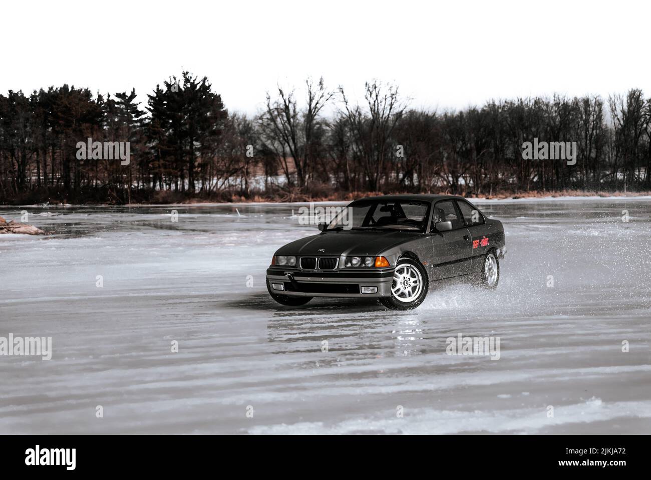 A view of a old black bmw car drifting on ice and snow Stock Photo - Alamy