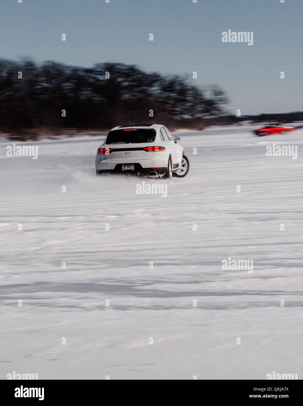 A white Porsche Cayenne car drifting on ice and snow in Juneau, Alaska ...