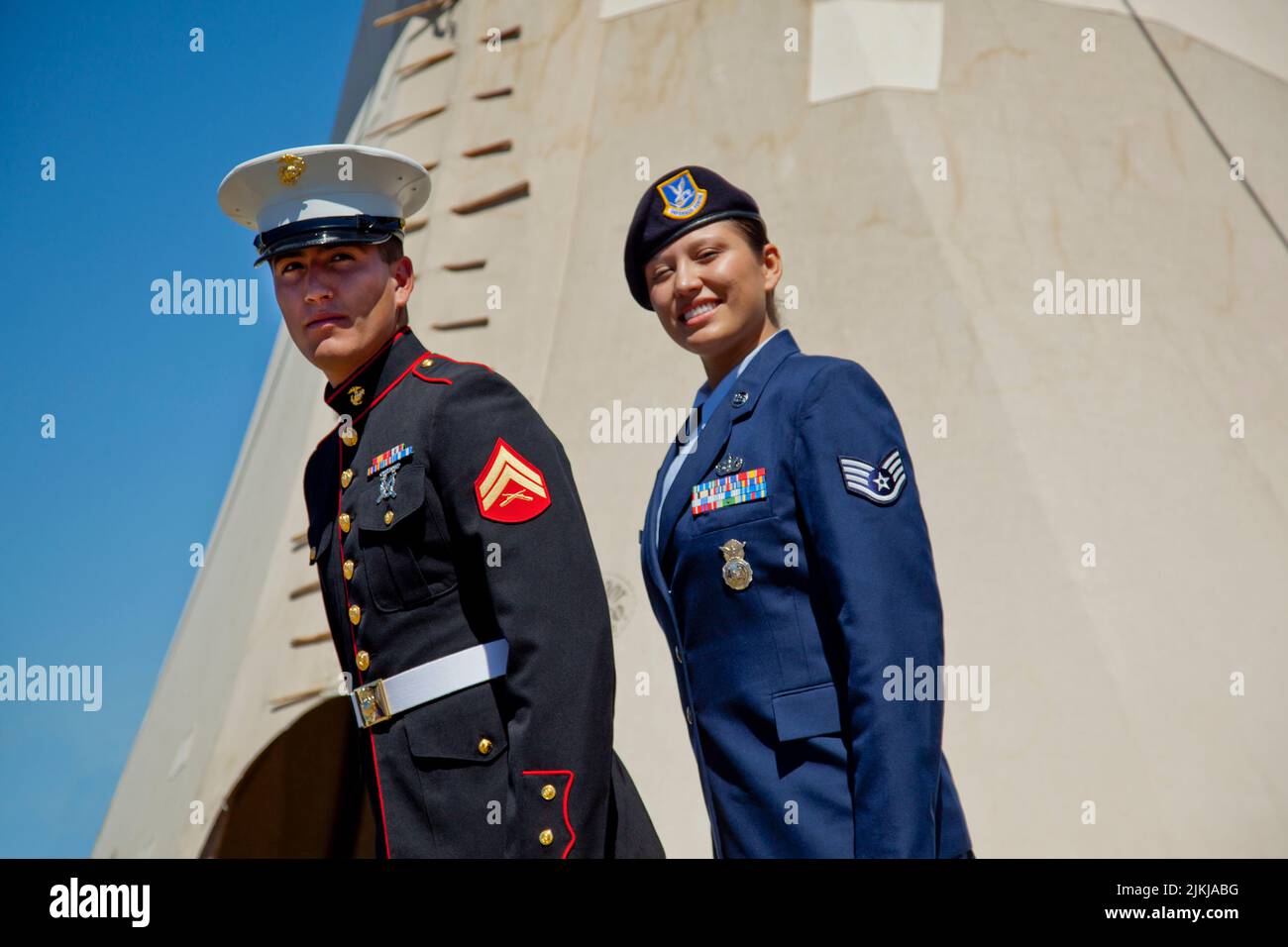 Military family of brother and sister in uniforms stand in front of a ...