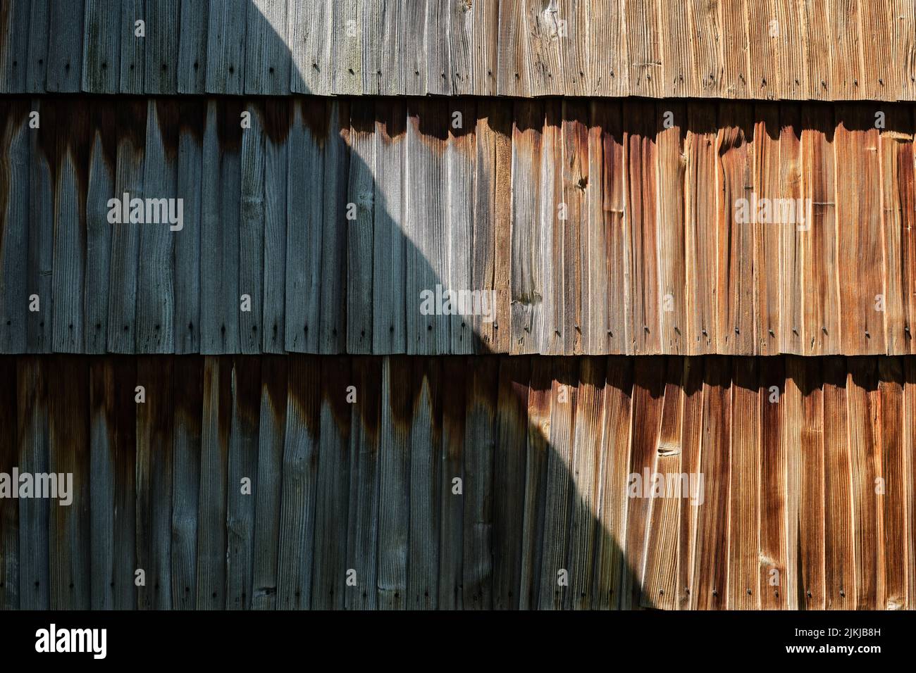 A wooden fence half under sunlight and the other half in shadow Stock ...