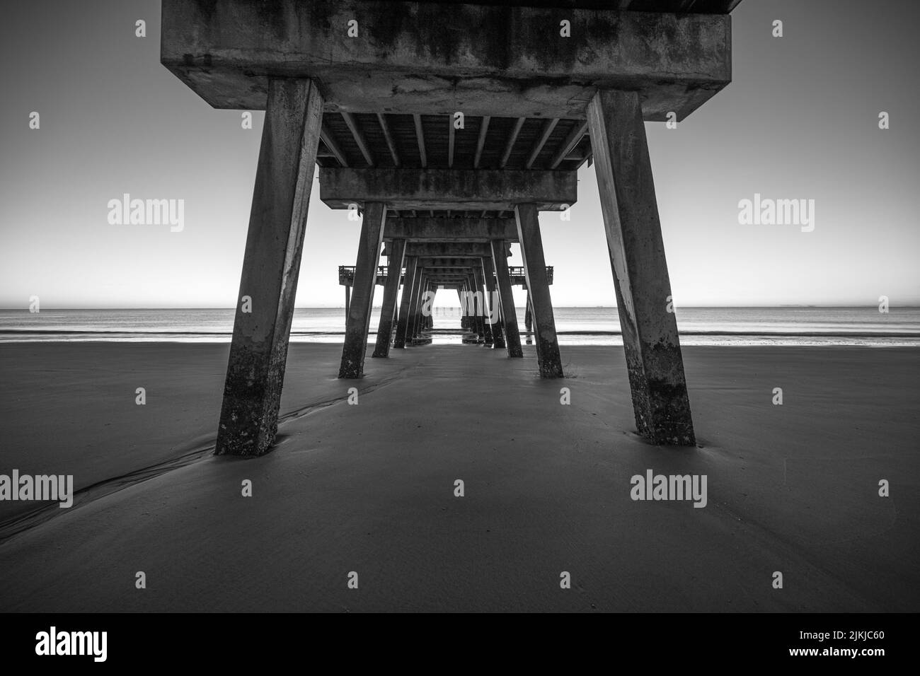 A grayscale of a bridge with the ocean in the background in Tybee ...