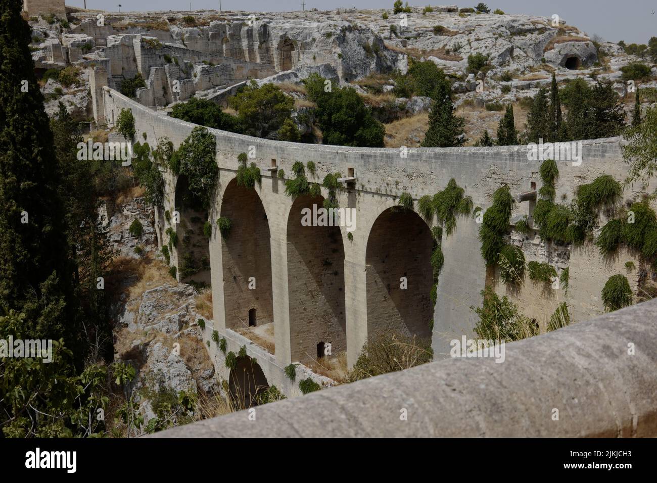 The famous stone arcade bridge in Gravina, Puglia, Italy surrounded by ...